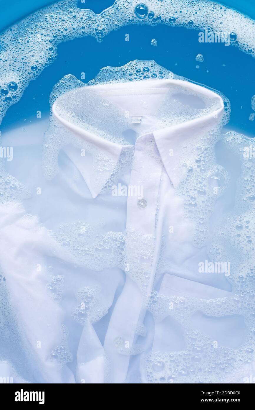White shirt soak in powder detergent water dissolution, washing cloth ...