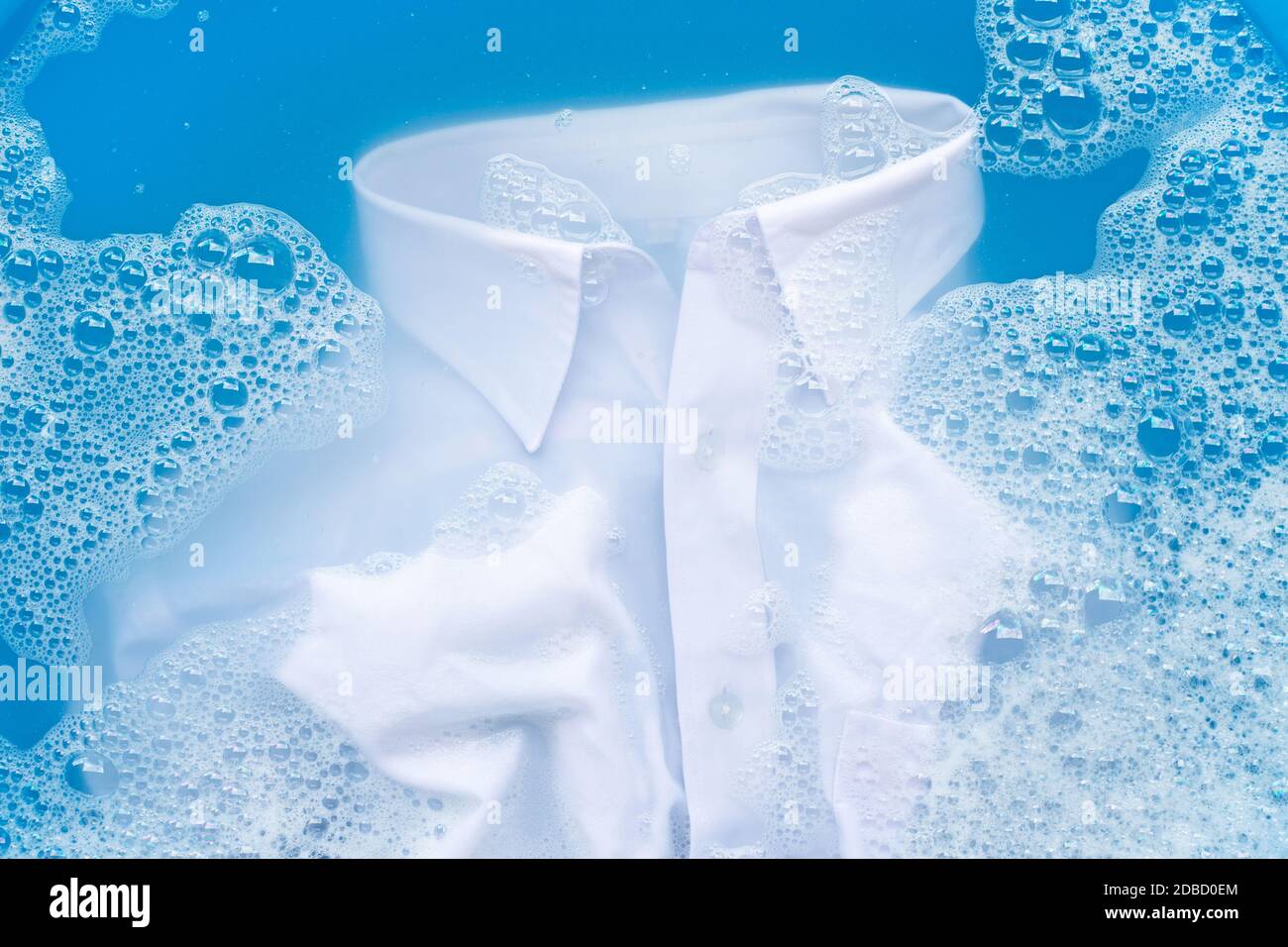 White shirt soak in powder detergent water dissolution, washing cloth ...