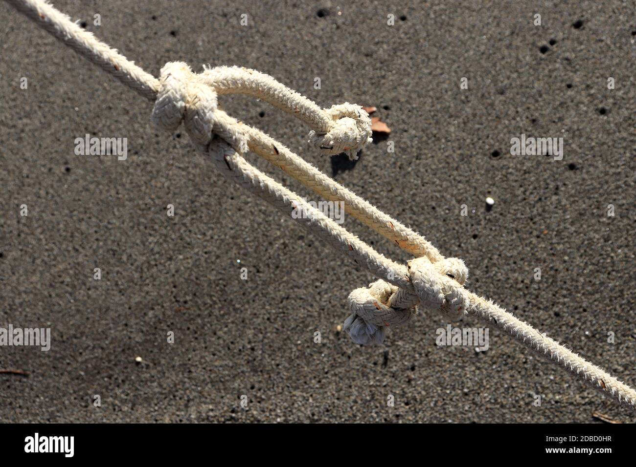 Rope with knots on sand background. Summer beach backdrop Stock Photo ...