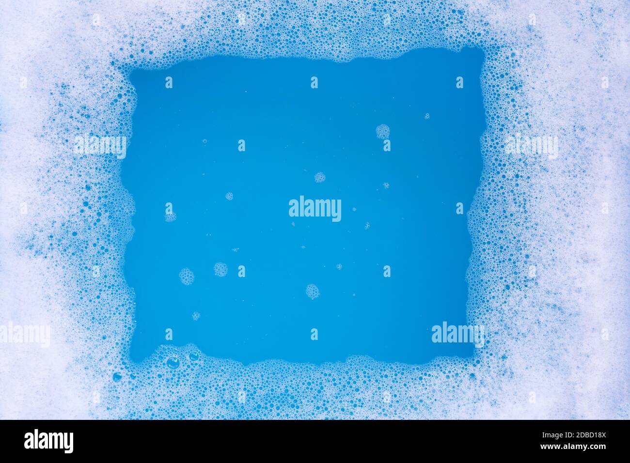 Frame made of detergent foam bubble. Blue background. Top view Stock ...