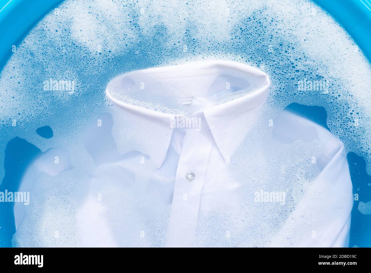 White shirt soak in powder detergent water dissolution, washing cloth ...