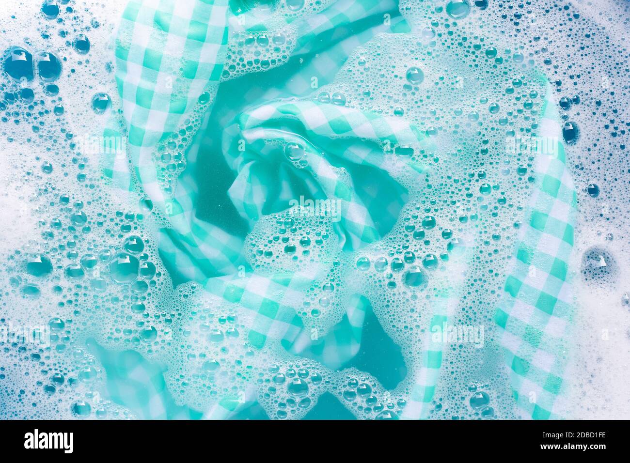 Green white tablecloth soak in powder detergent water dissolution ...