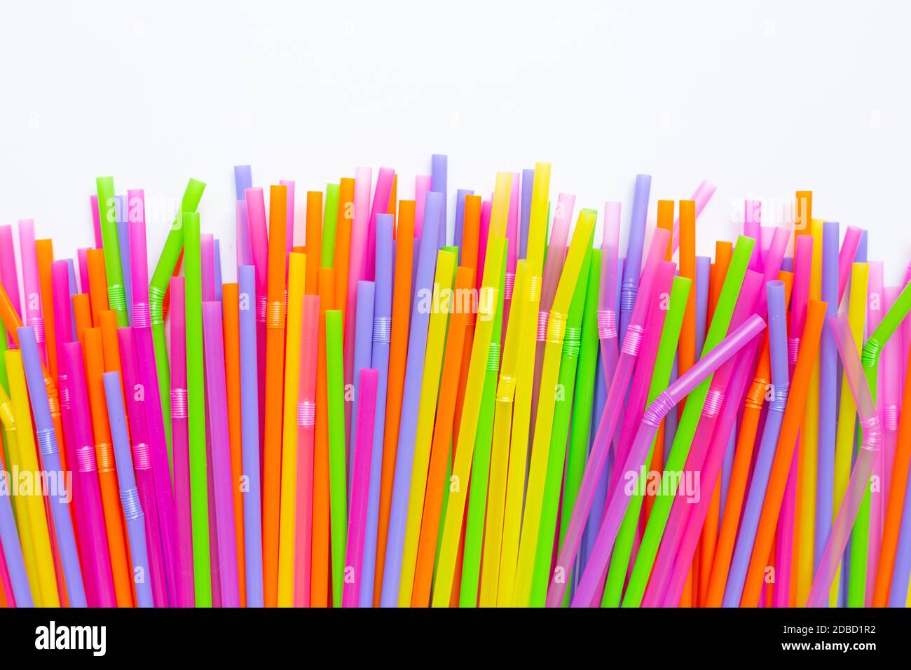 Colorful plastic straws on white background. Plastic waste pollution ...