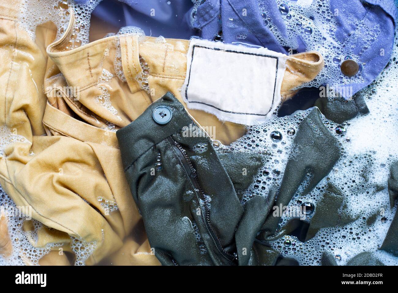 Trousers soak in powder detergent water dissolution, washing cloth ...