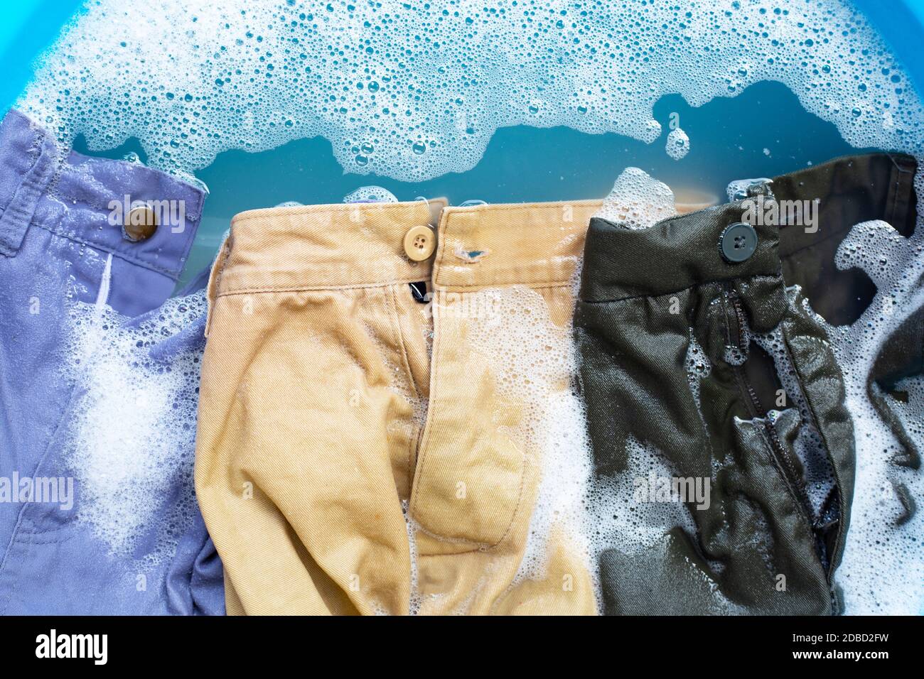 Trousers soak in powder detergent water dissolution, washing cloth ...