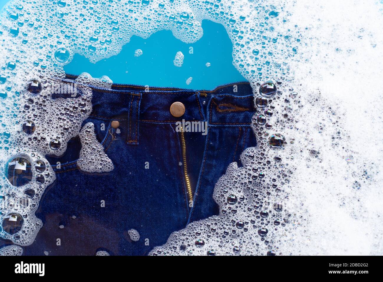 Jeans soak in powder detergent water dissolution, washing cloth ...