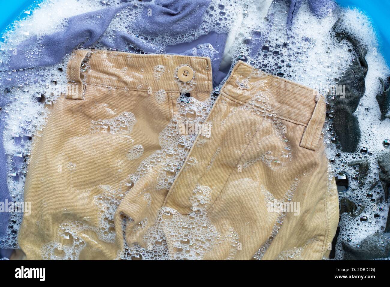 Trousers soak in powder detergent water dissolution, washing cloth ...
