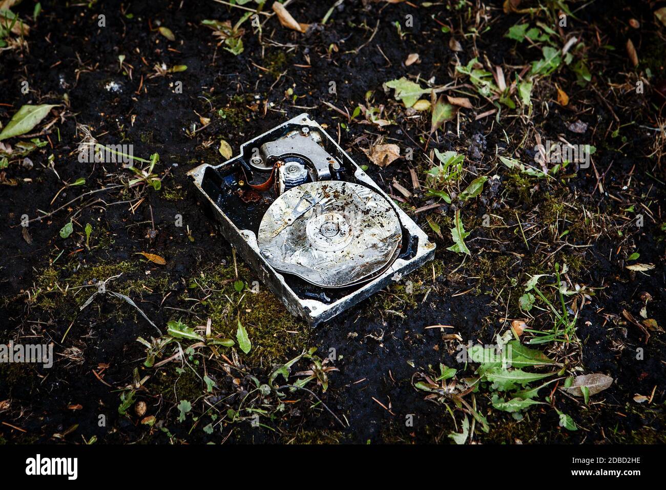 Crushed Hard Disk Drive on the Dirty Ground closeup Stock Photo - Alamy