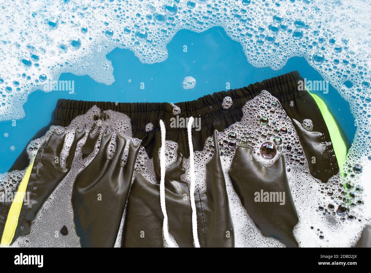 Male shorts soak in powder detergent water dissolution, washing cloth ...