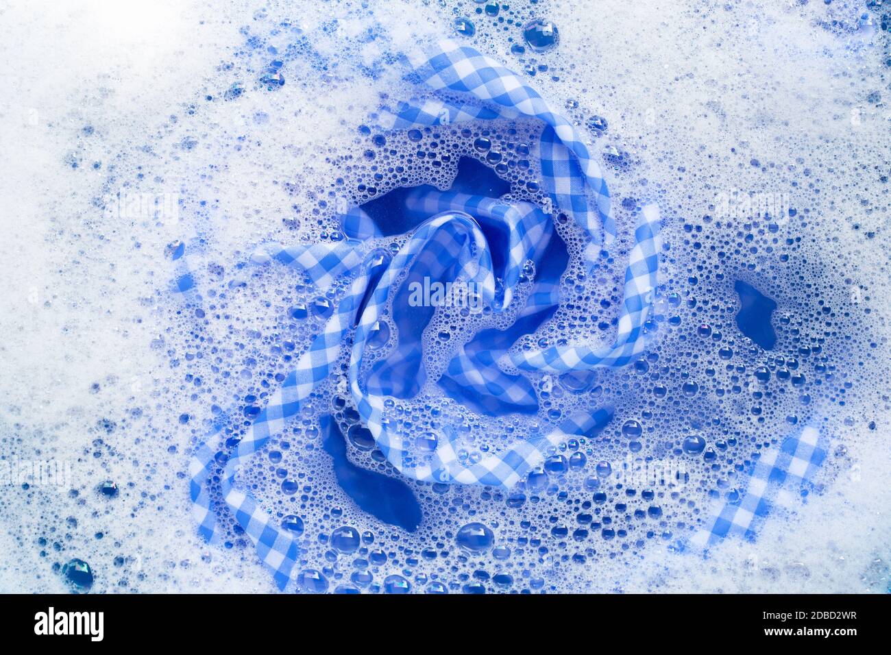Blue white tablecloth soak in powder detergent water dissolution ...