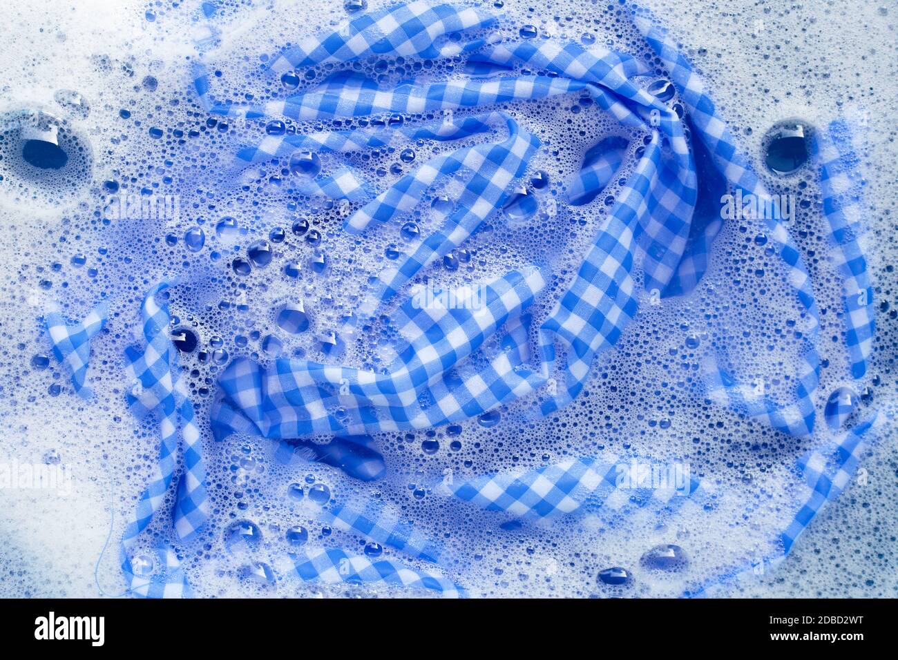 Blue white tablecloth soak in powder detergent water dissolution ...