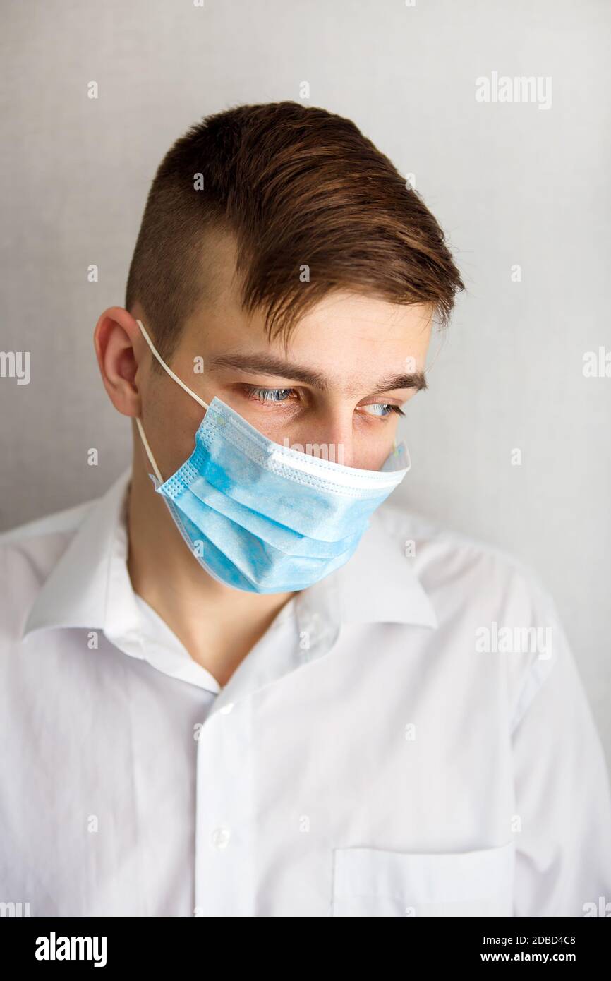 Portrait of Young Man in a Flu Mask by the Wall in the Room Stock Photo ...