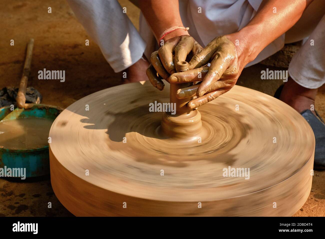 Pottery - skilled hands of potter shaping the clay on potter wheel ...