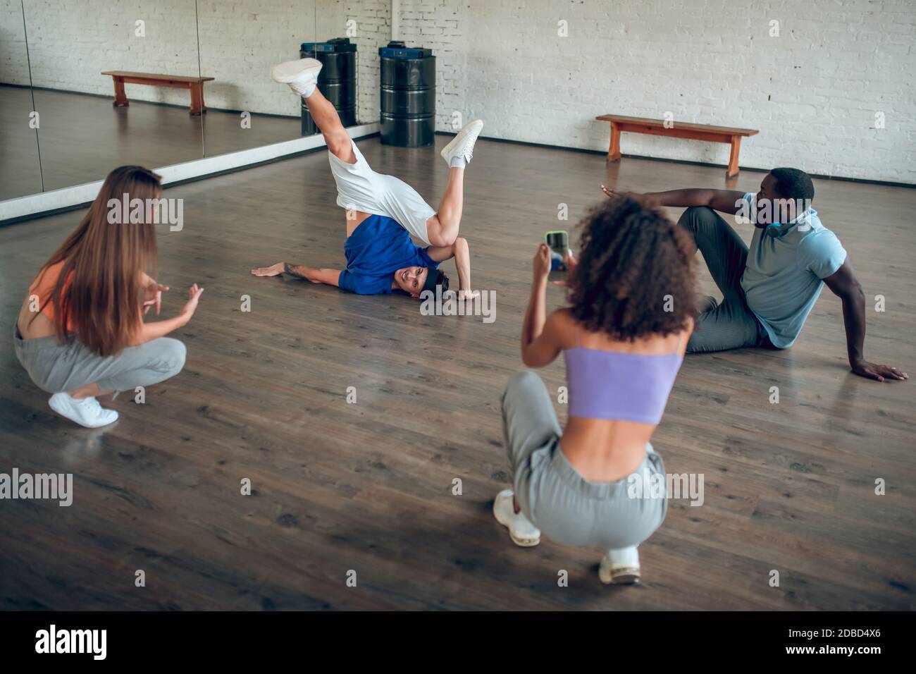 Teacher showing breaking routine to his students Stock Photo - Alamy