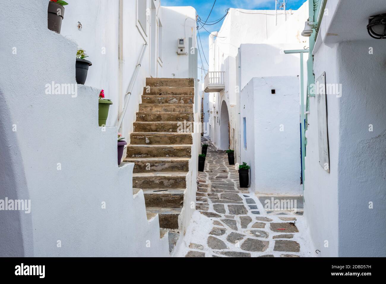 Picturesque narrow street with traditional whitewashed houses of Naousa ...