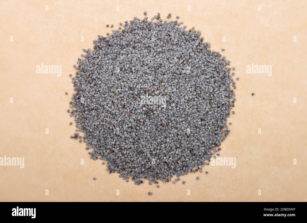 Poppy seeds on brown background Stock Photo - Alamy