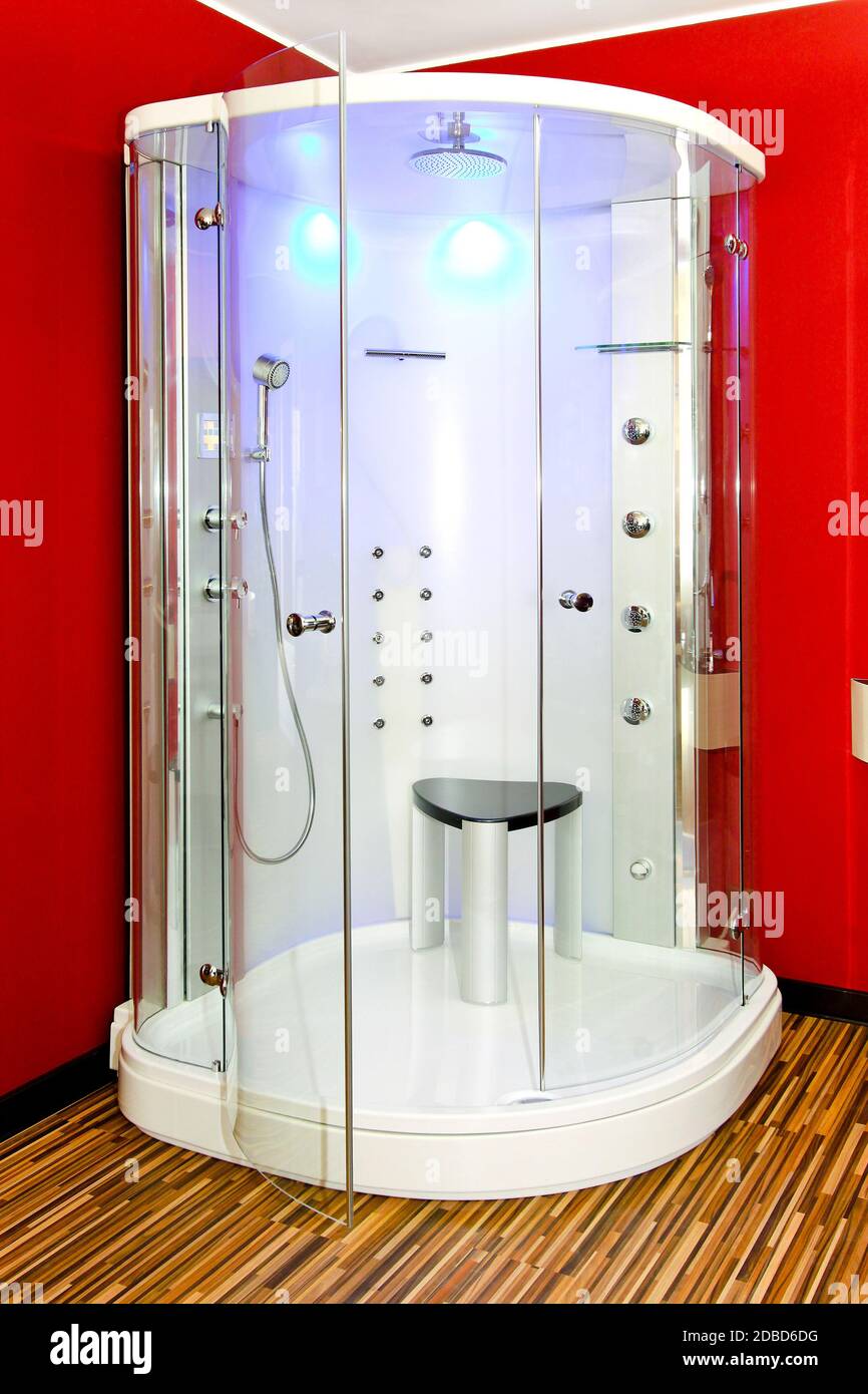 Shower cabin with hydro jets in red bathroom Stock Photo - Alamy