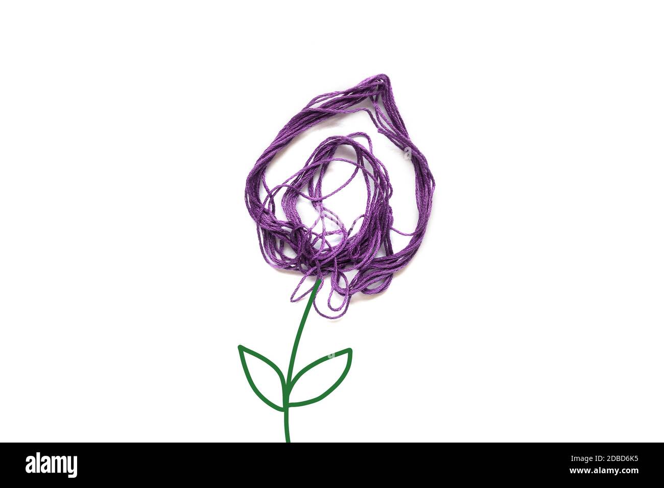 Purple flower made of thread on white background. Stem and leaves ...