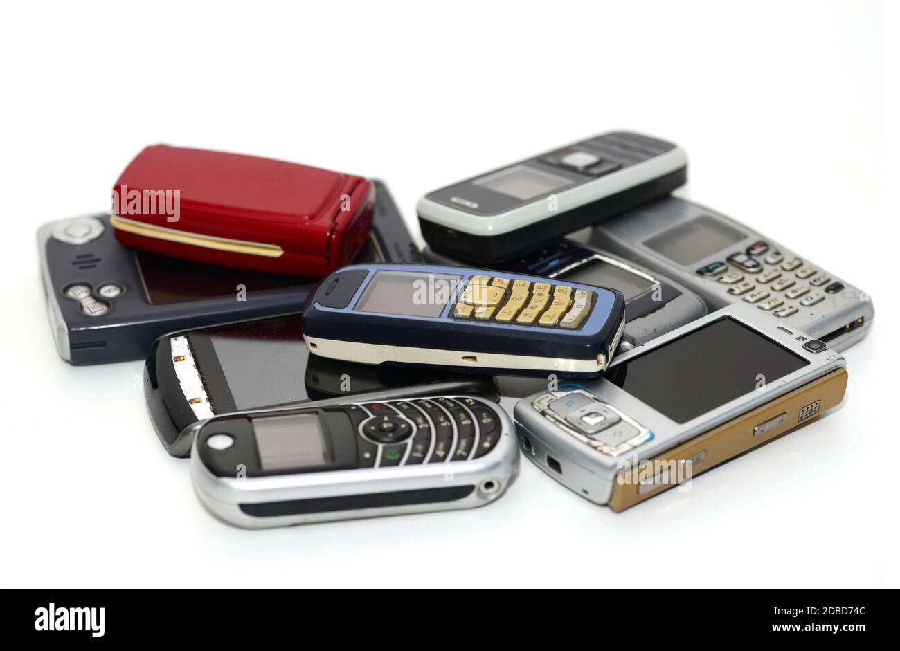 pile of used old mobile damaged phones technology background Stock ...