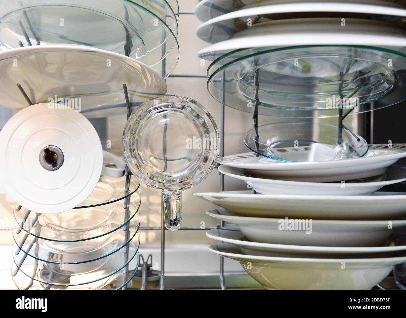 Top view of cleaned plates and different dishes in dishwasher rack ...