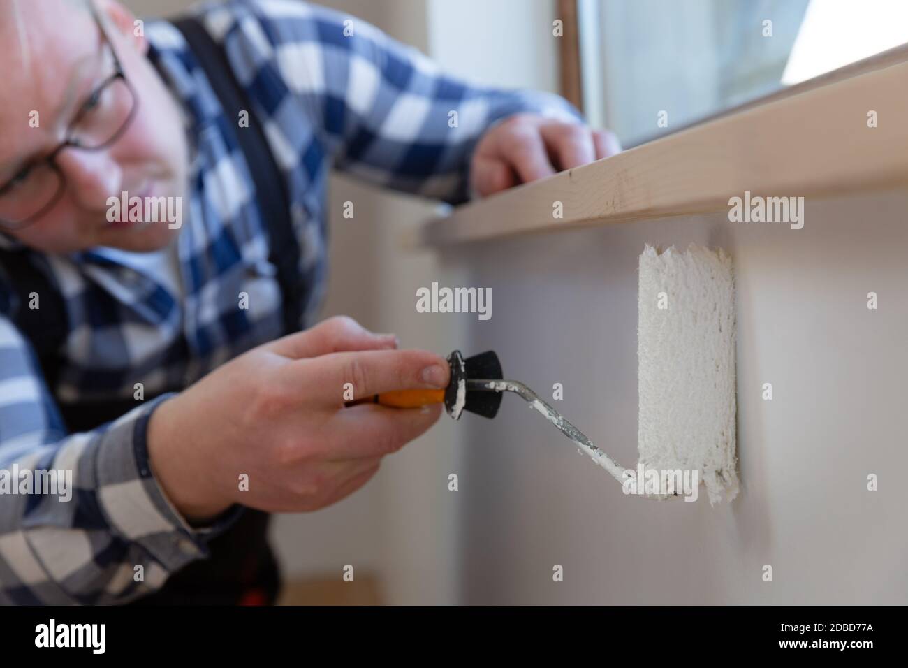 Maintenance worker fixing a window hi-res stock photography and images ...