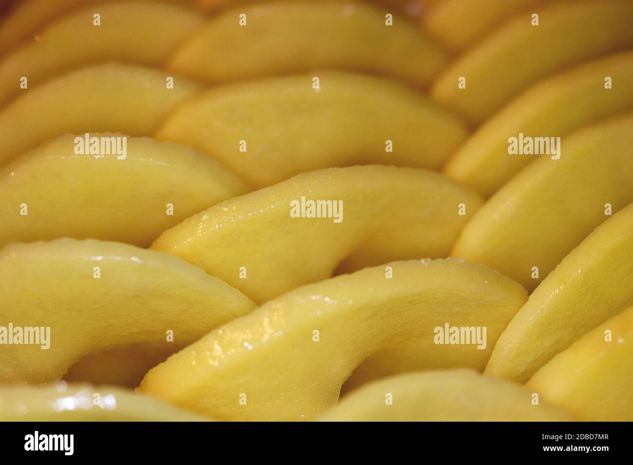 Loop slices potatoes backdrop. Raw spiral potato background. Vegetable ...
