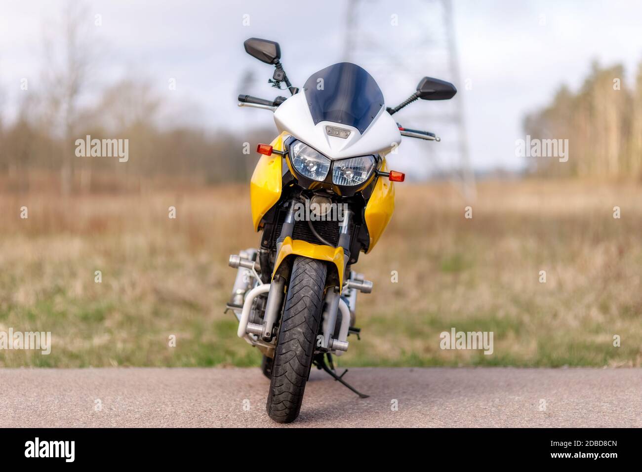 motorcycle standing on the side of a yellow road, front view Stock ...