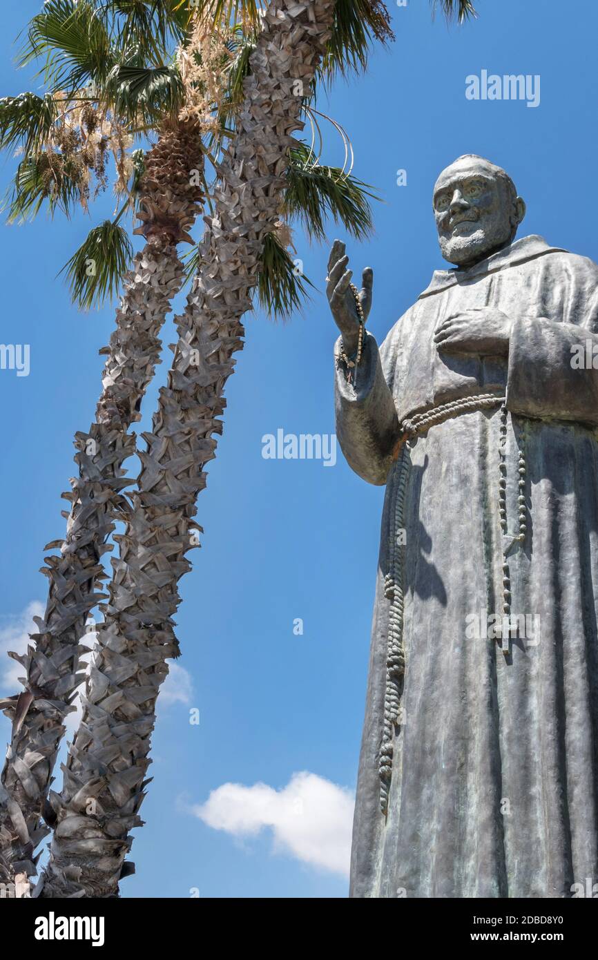 Statue of Saint Father Pio on sky background. Ideal for concepts or ...