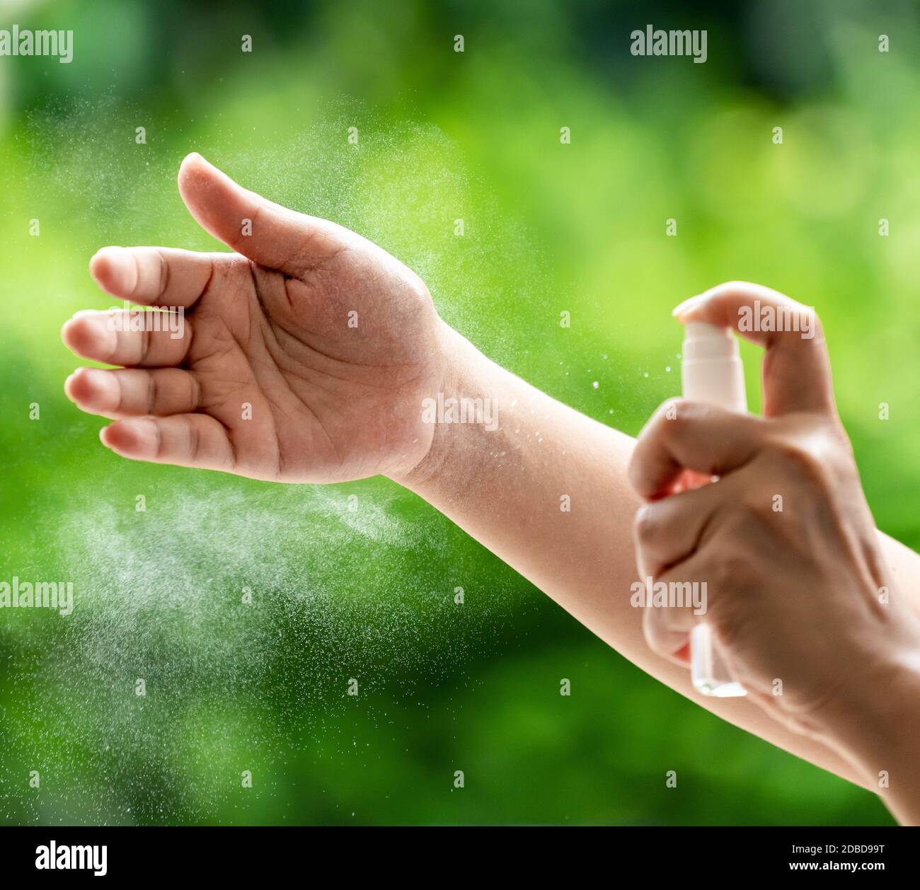 close-up cleaning hand using alocohol spray Hand sanitazer from bottle ...