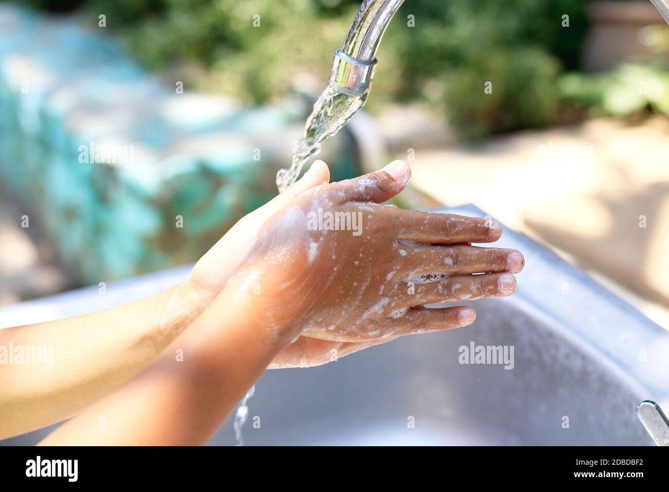 Close-up of a person washing hands with water outdoors Stock Photo - Alamy