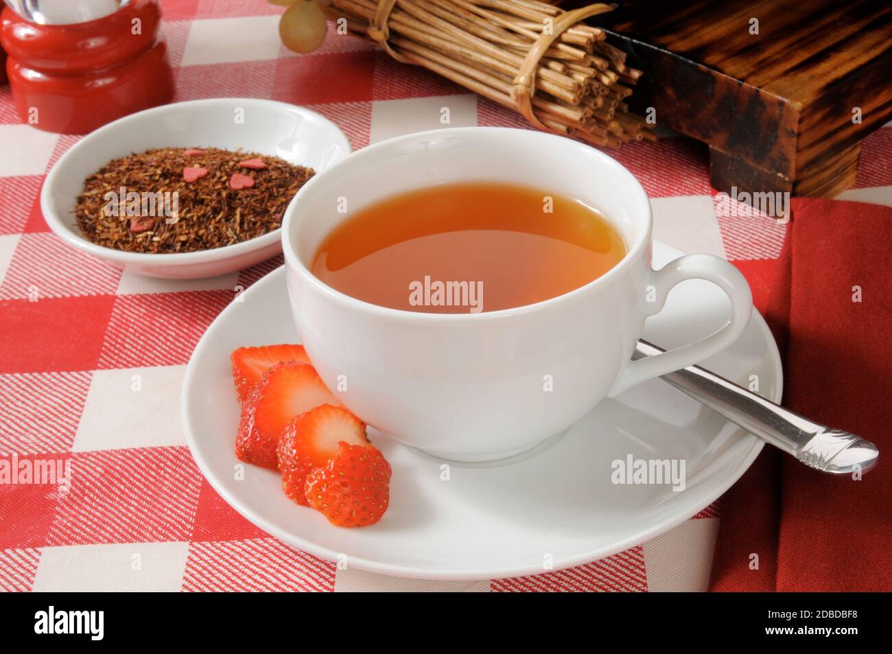 A cup of strawberry infused rooibos tea with fresh strawberry Stock ...