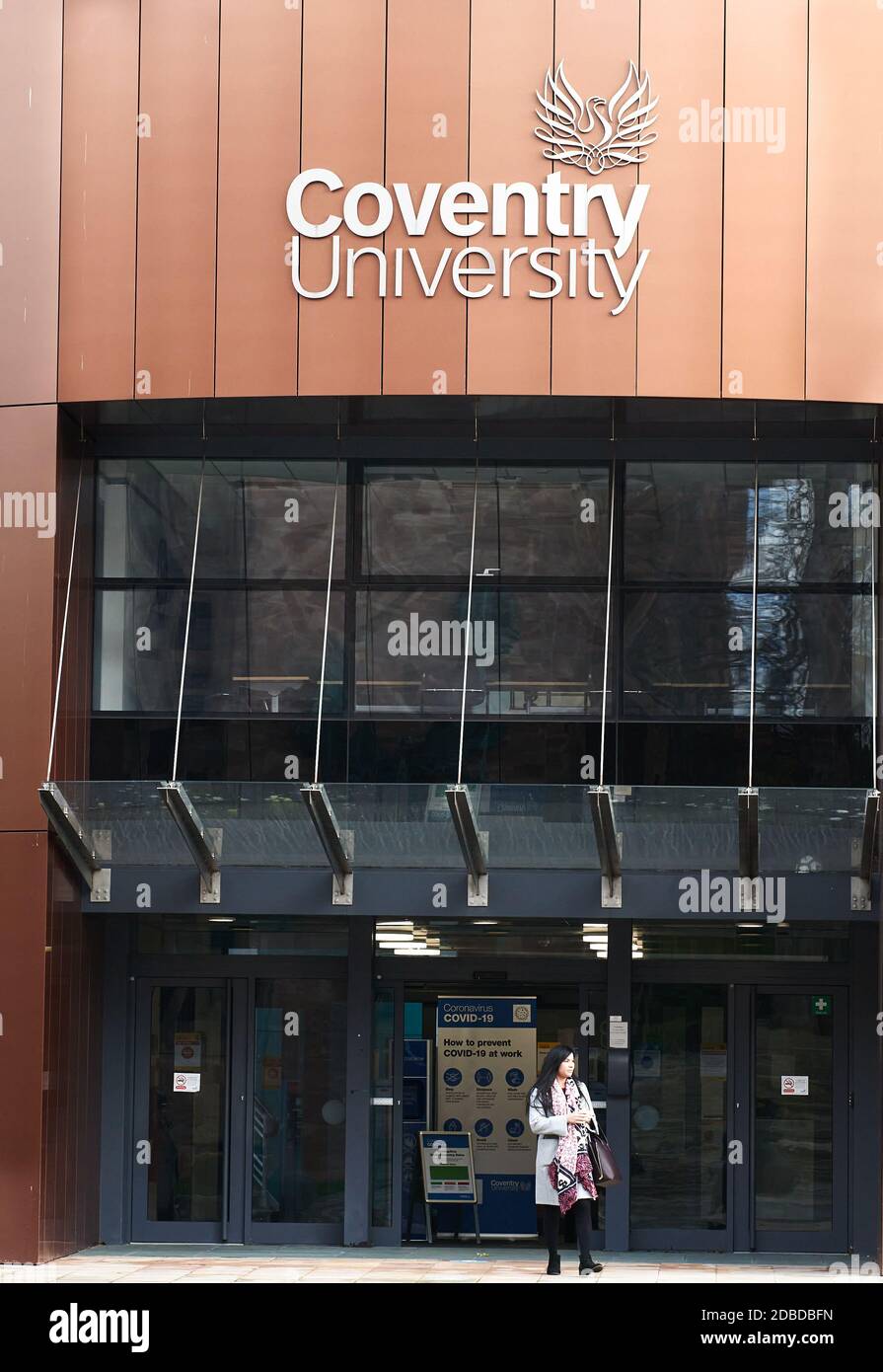 A student stands at the entrance and exit to and from the Alan Berry ...