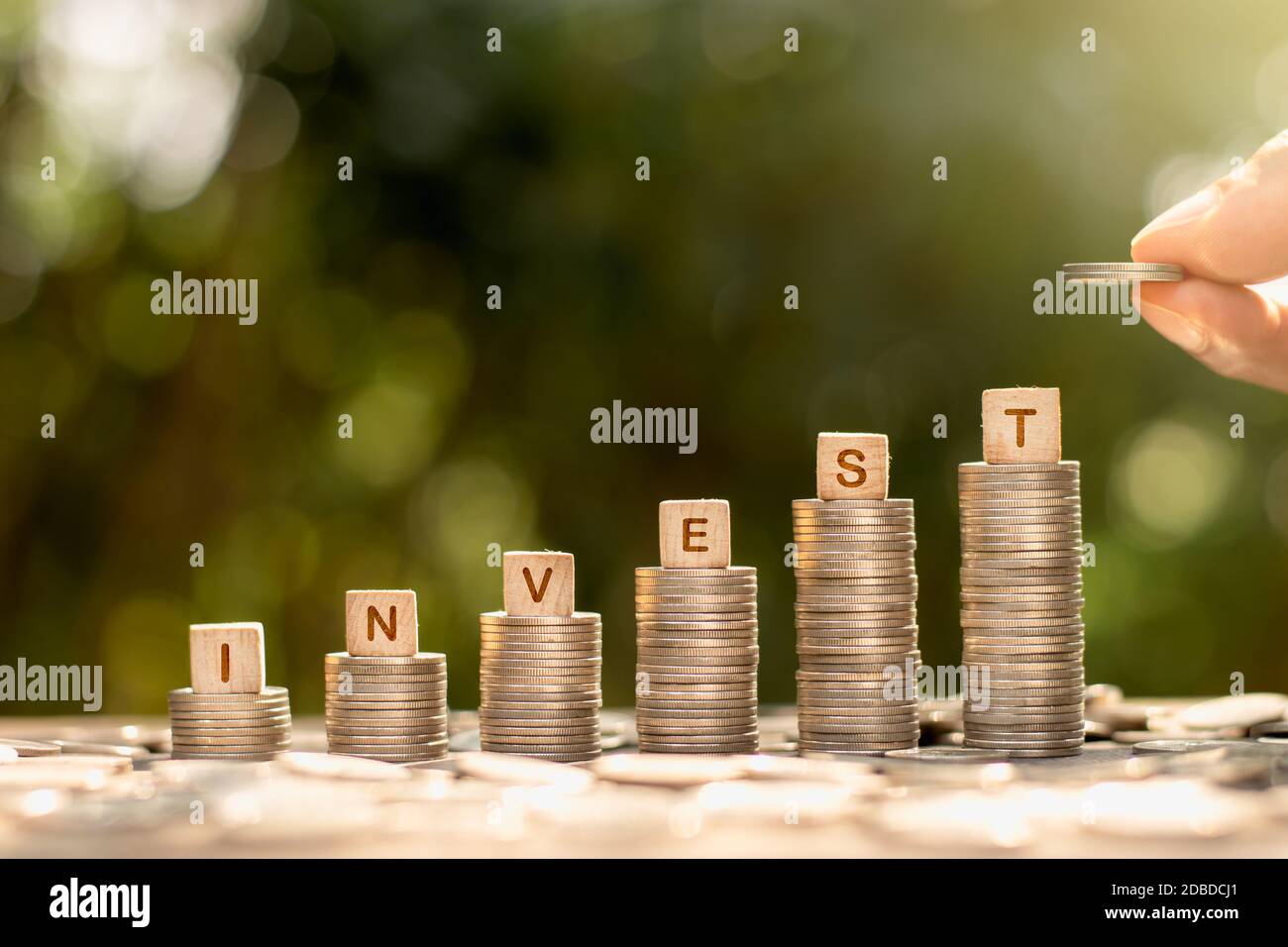 The coins are stacked, lots of things, and the hands of a man are ...