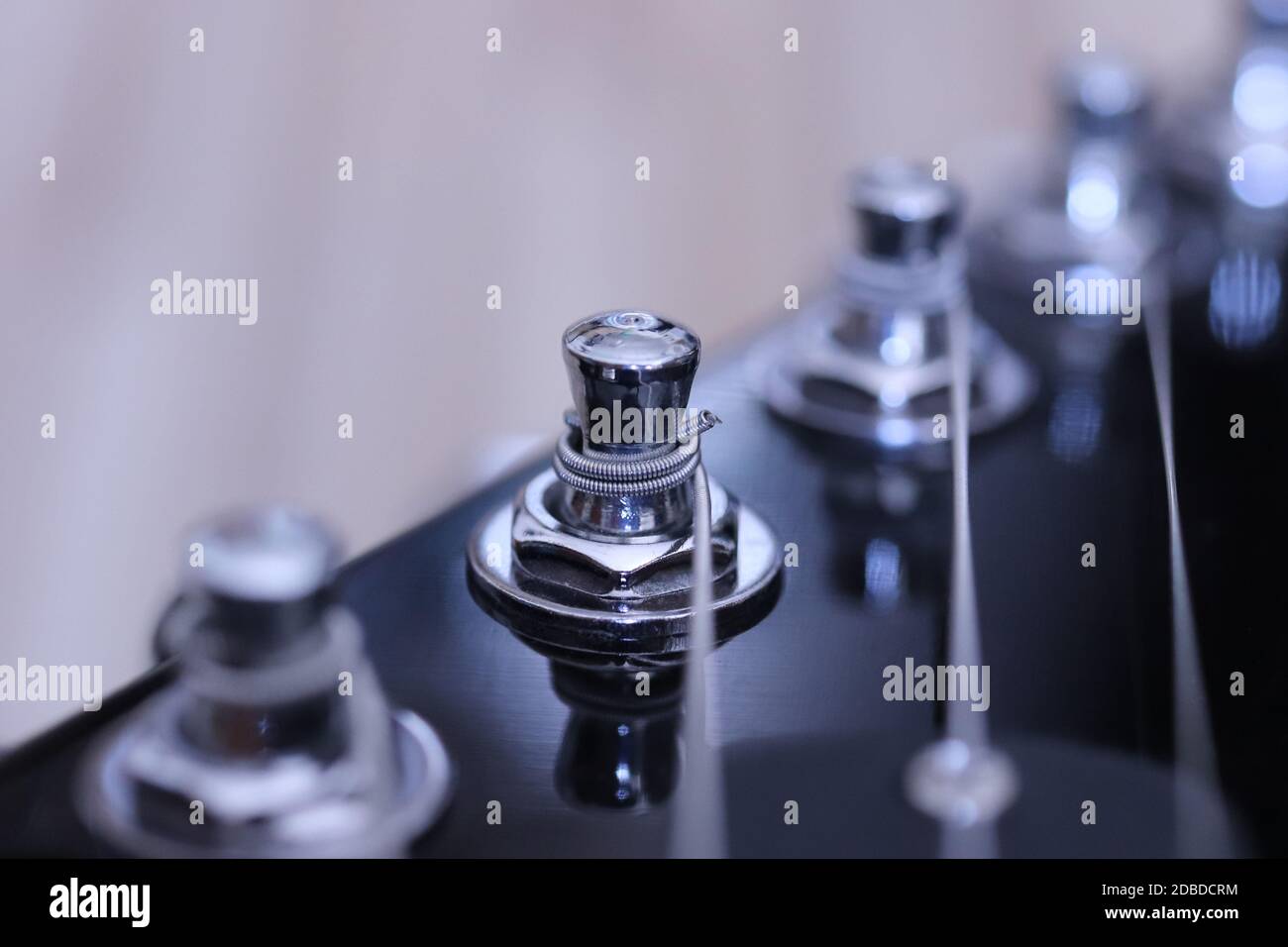 Holding string guitar tuning key. Music instruments background ...