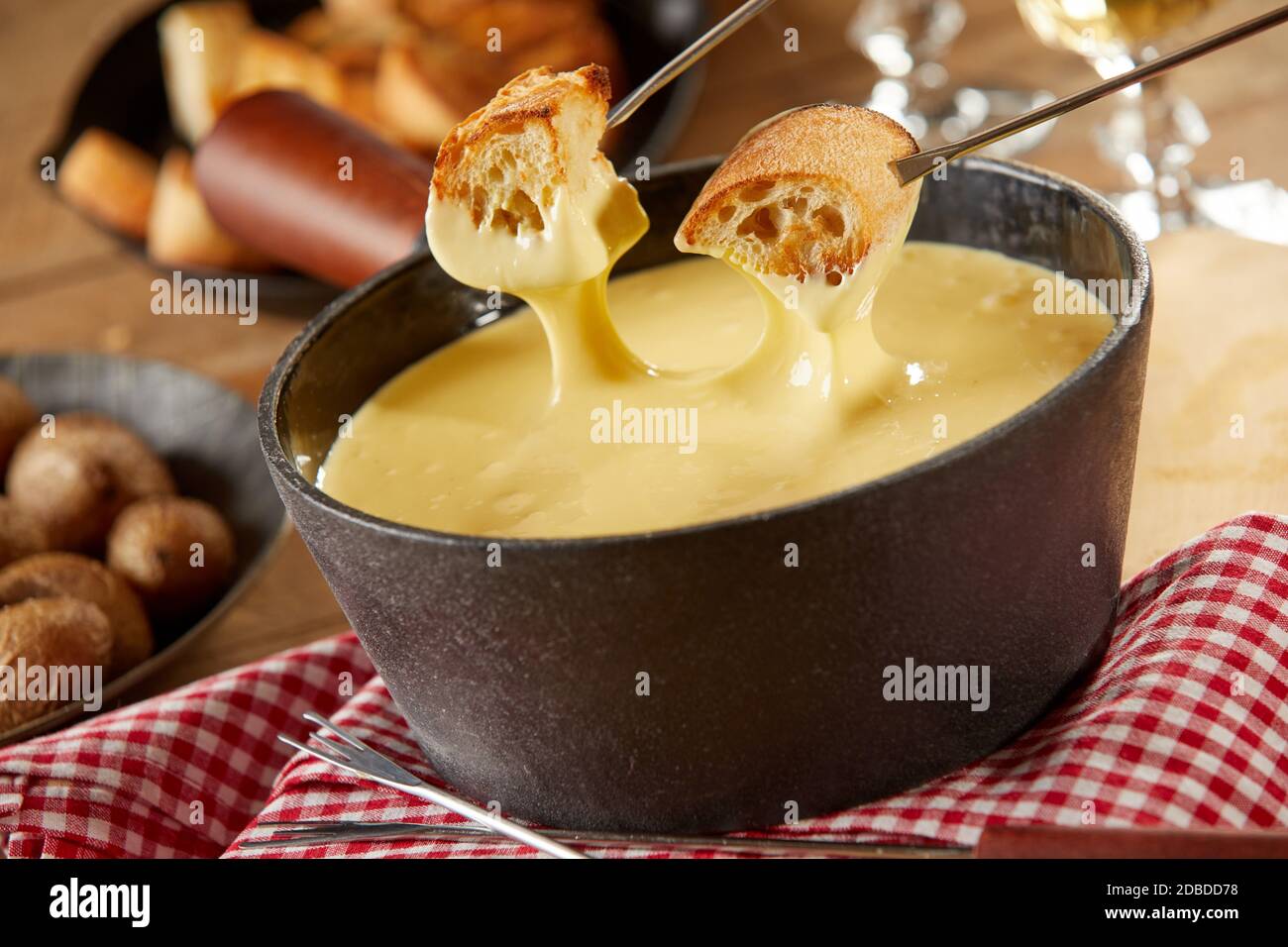 Traditional Swiss cheese fondue in cast iron pot in close up on a ...