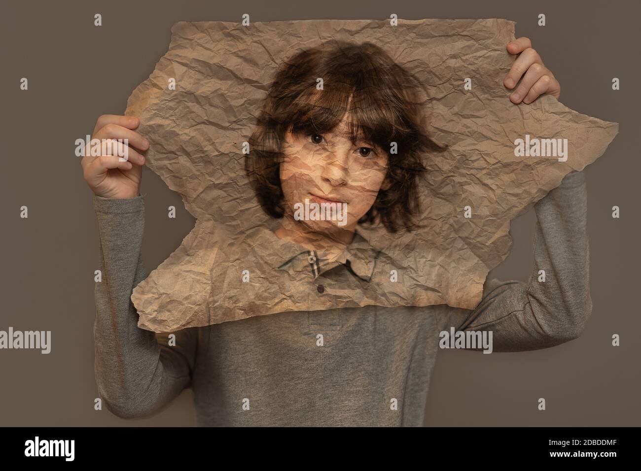 Portrait of a boy on crumpled paper. Creative double exposure effect ...