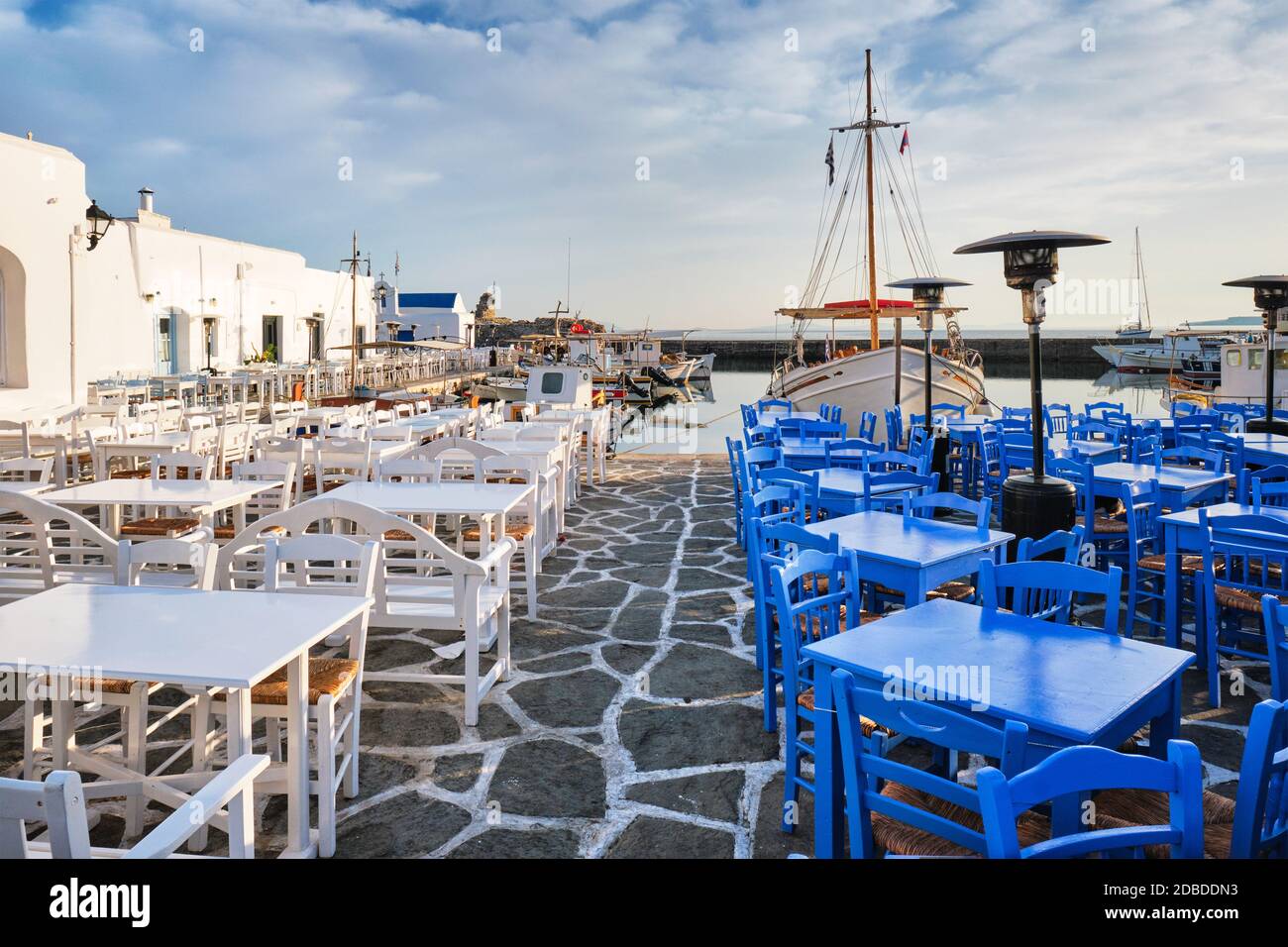 Cafe tables on quay of Naousa town port in famous tourist attraction ...