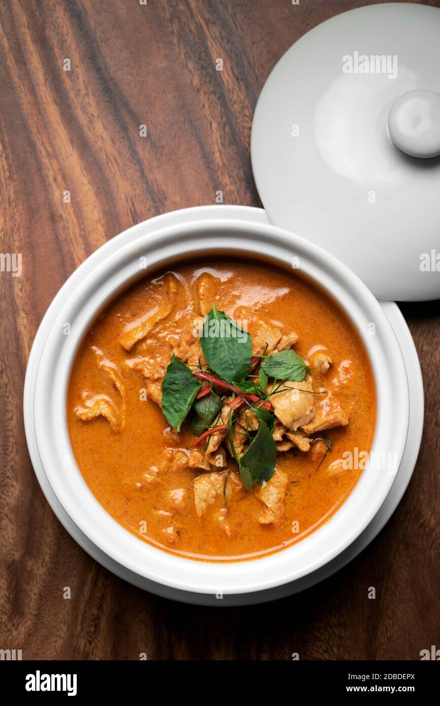 thai spicy panang pork curry with coconut milk on wood table in Phuket ...