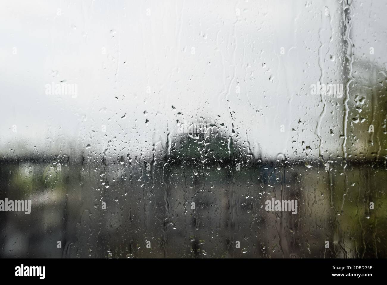 Raindrops on the window pane. Blurred background outside the window in the rain Stock Photo - Alamy