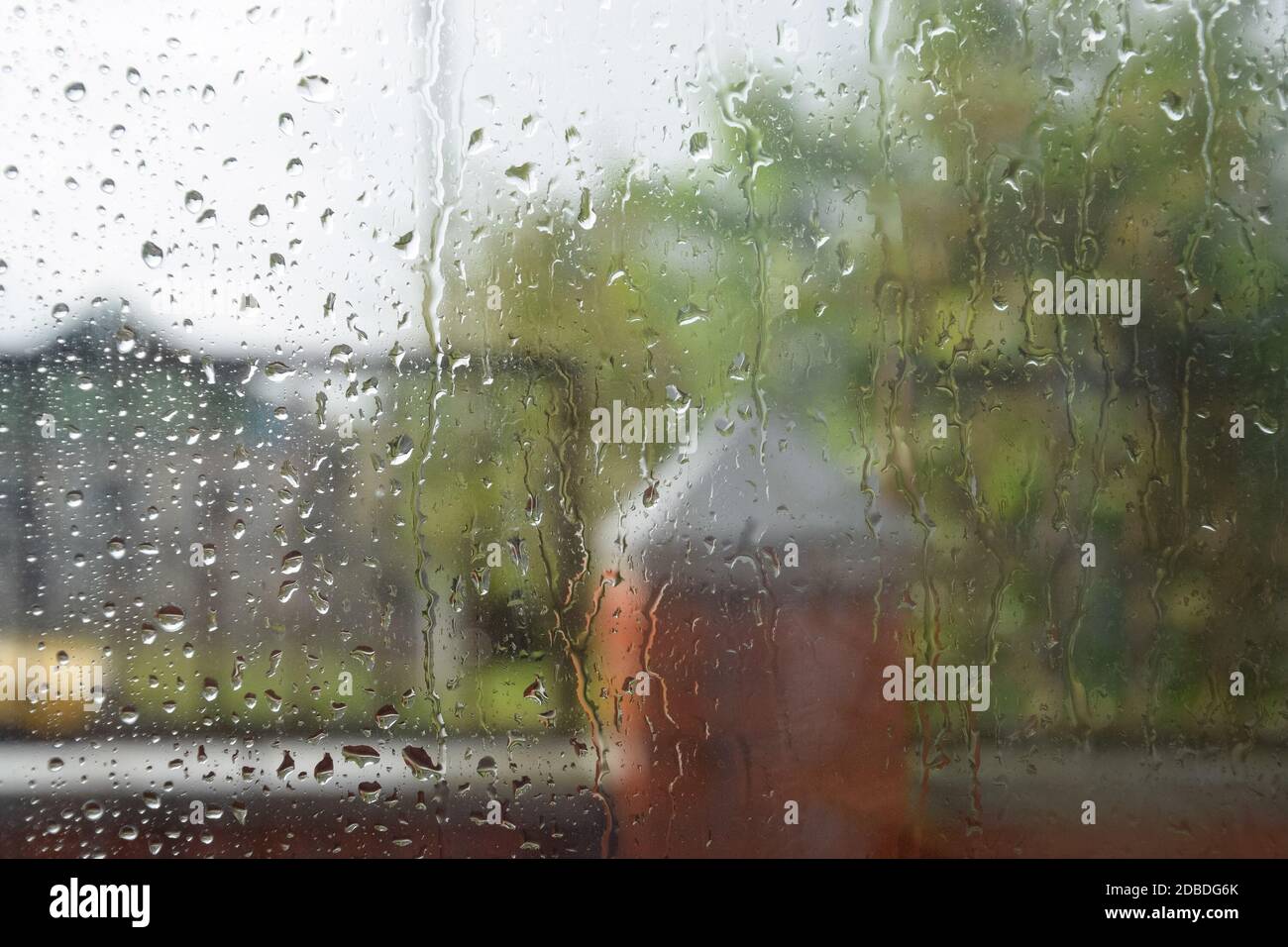 Raindrops on the window pane. Blurred background outside the window in the rain Stock Photo - Alamy