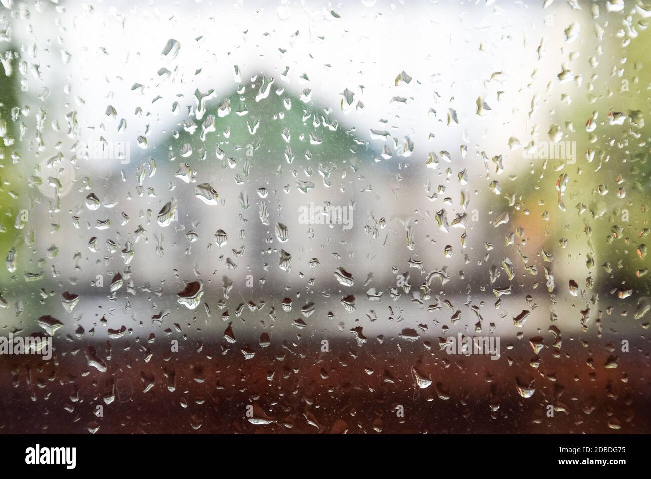 Raindrops on the window pane. Blurred background outside the window in the rain Stock Photo - Alamy