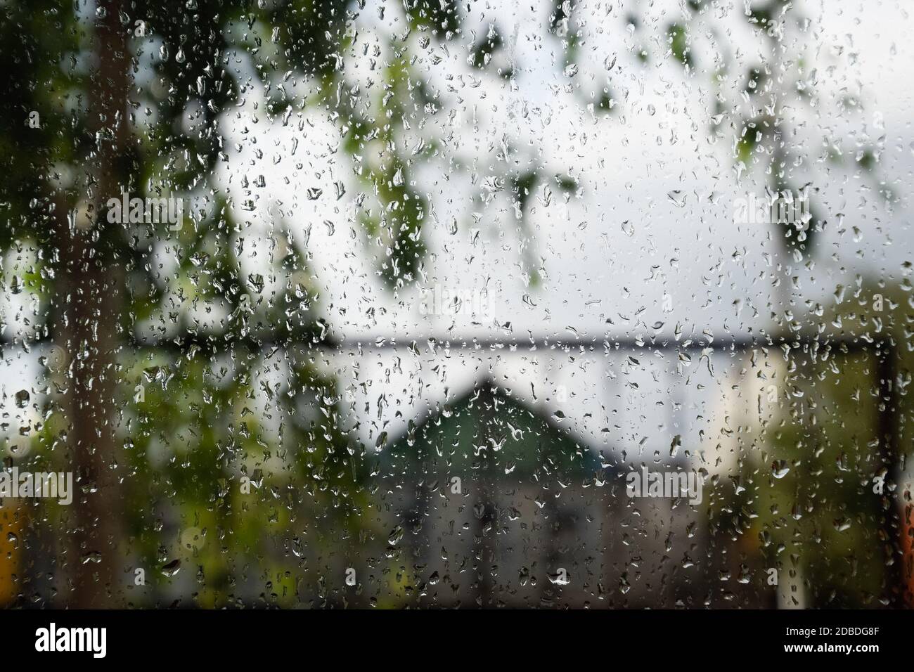 Raindrops on the window pane. Blurred background outside the window in the rain Stock Photo - Alamy