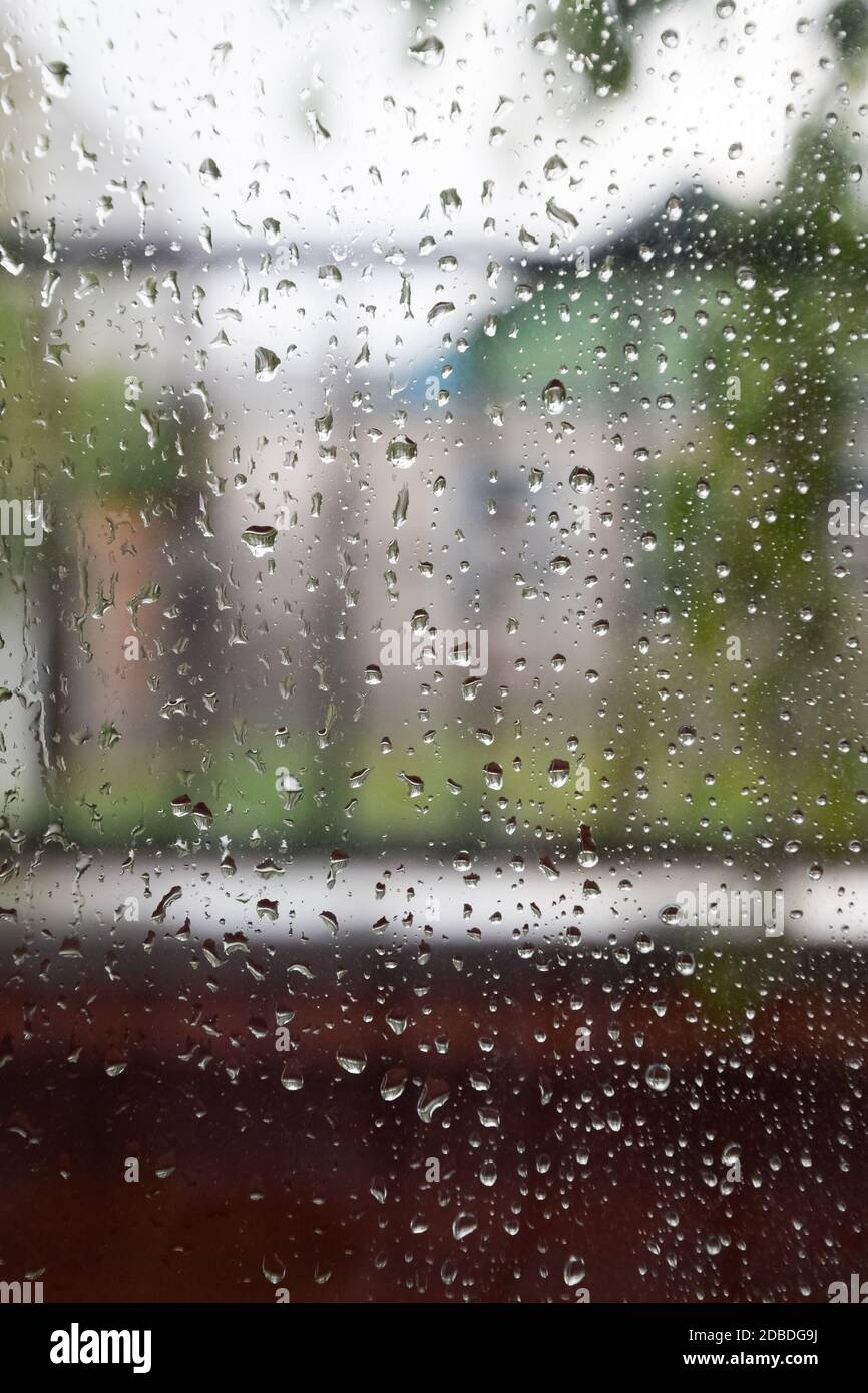 Raindrops on the window pane. Blurred background outside the window in the rain Stock Photo - Alamy