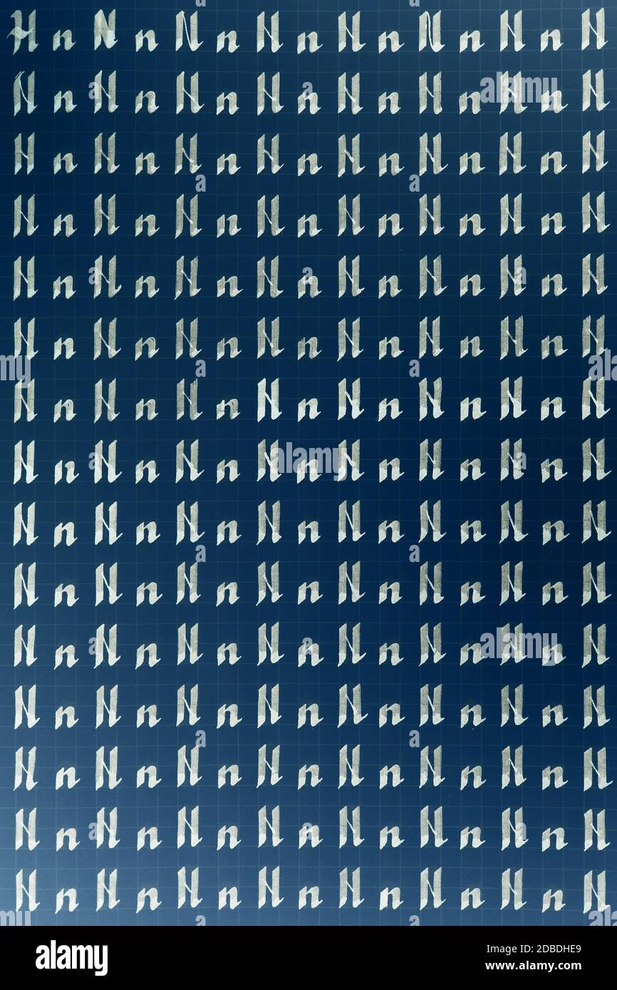 Calligraphic white on dark blue letter N learning skills paper page ...