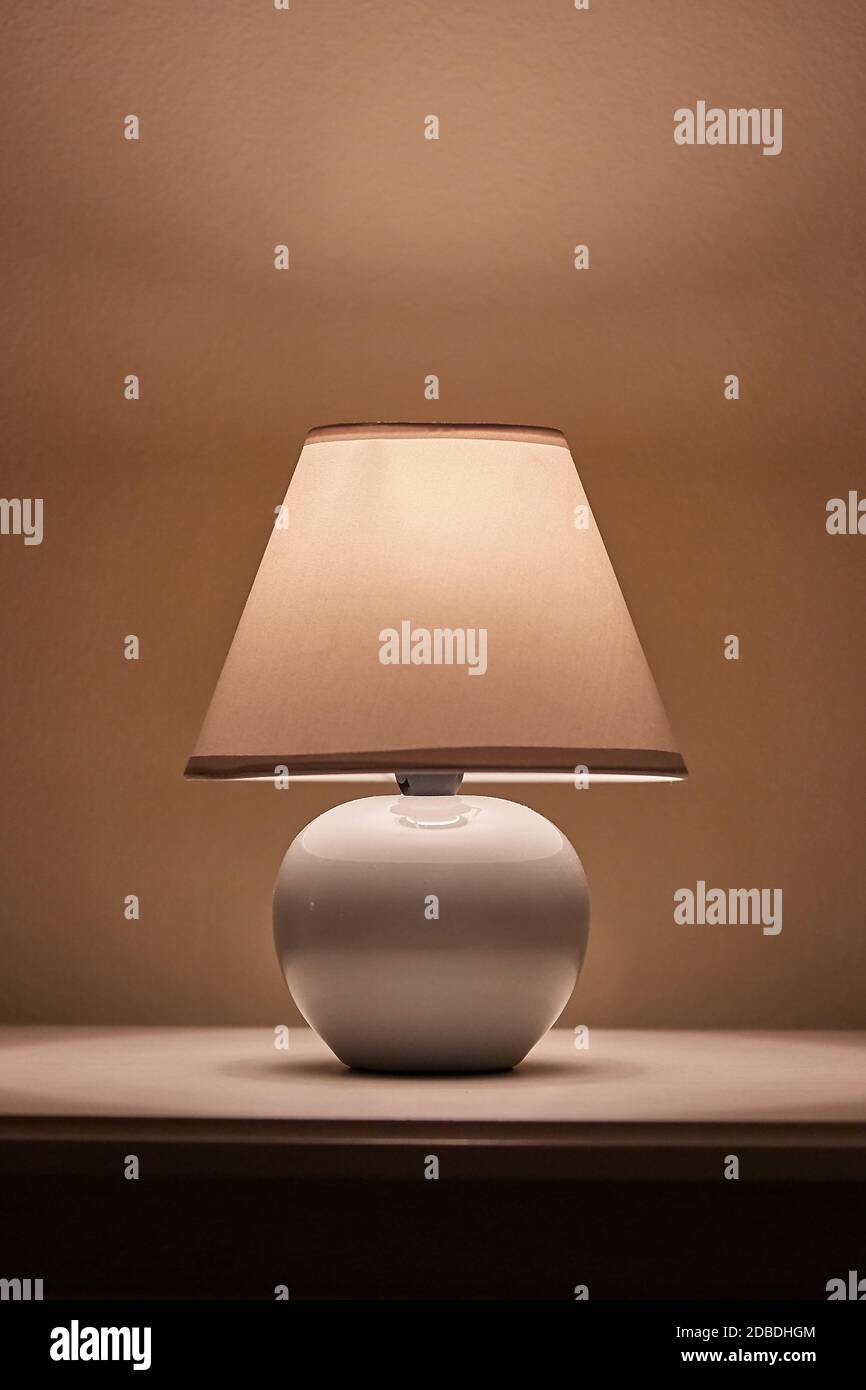Small lamp glowing in bedroom, close up Stock Photo - Alamy