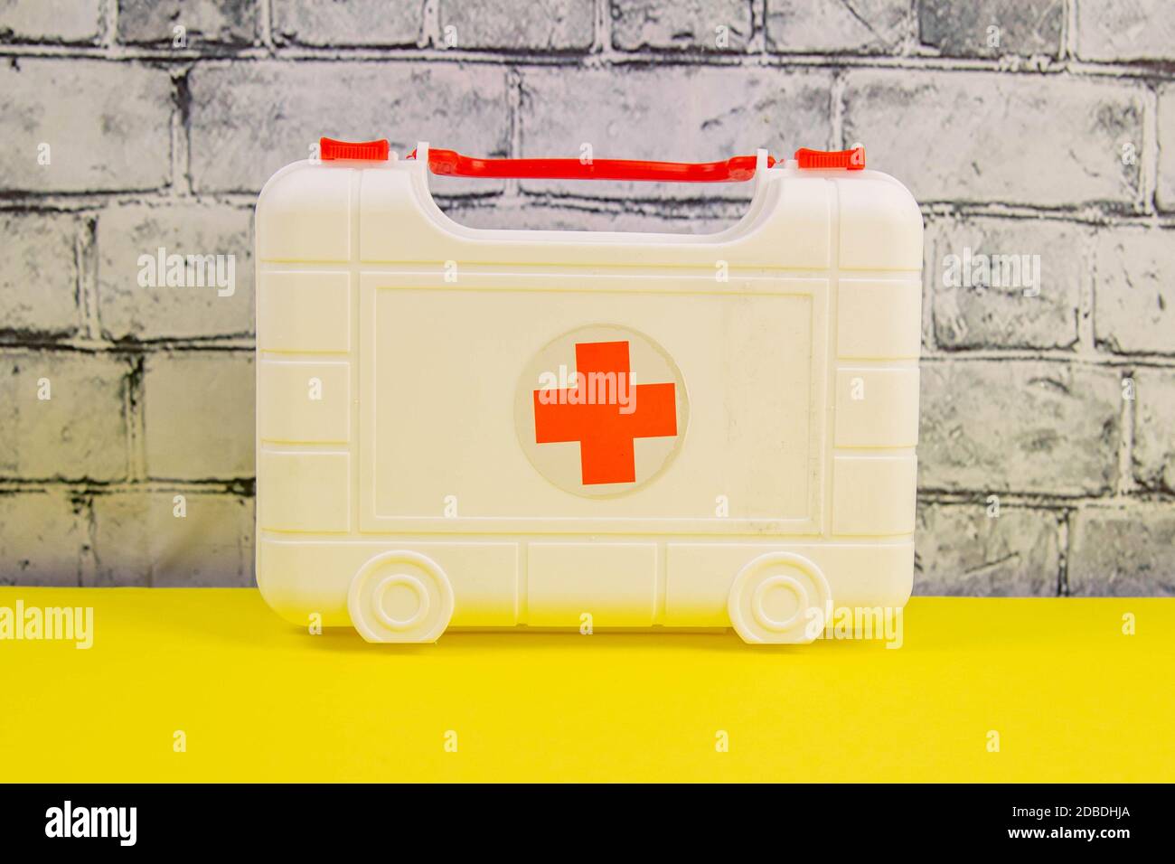 Toy - First aid kit on yellow table. Set of little doctor. Close-up ...