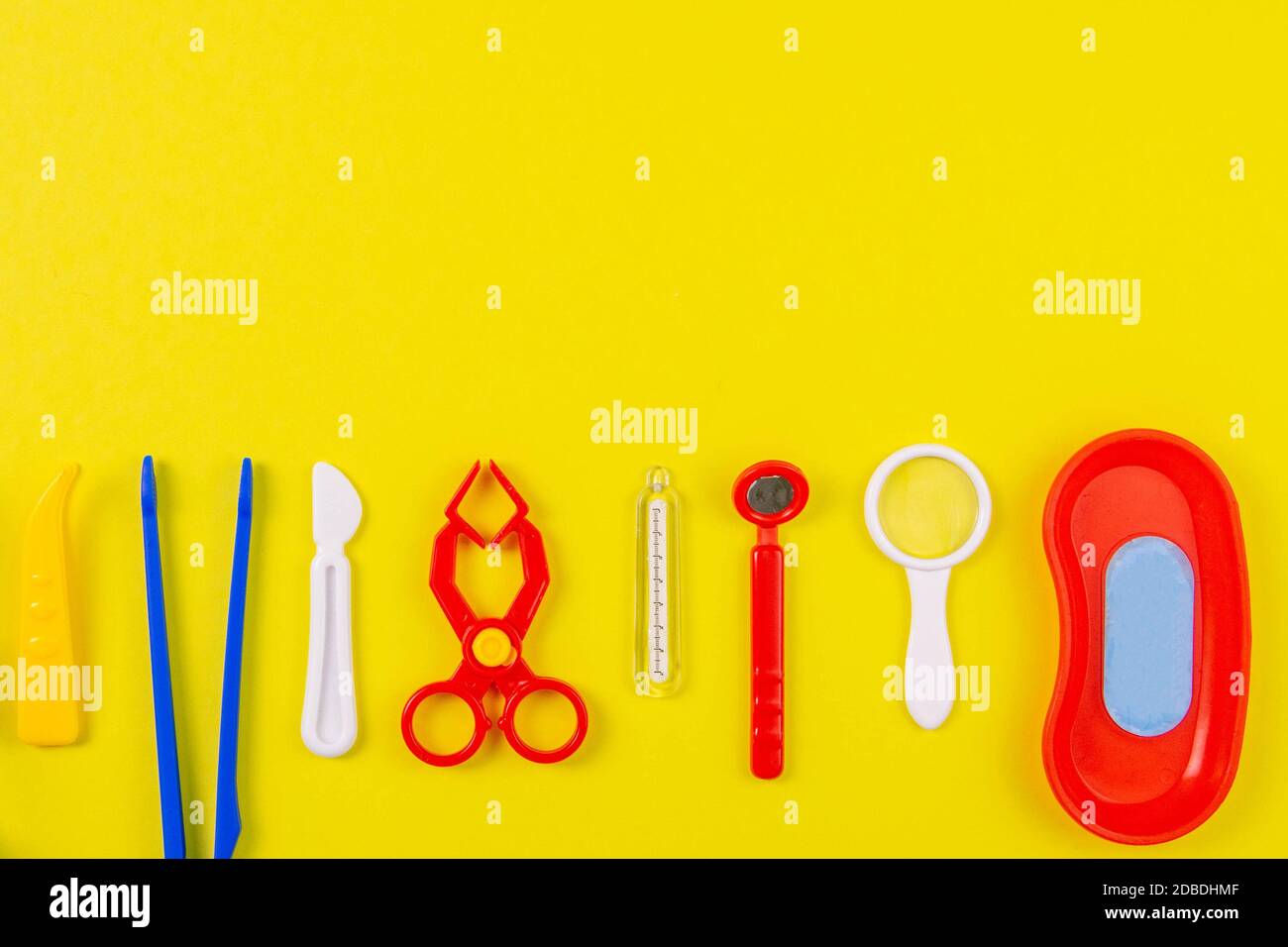 Toy - First aid kit on yellow table. Set of little doctor. Top views ...