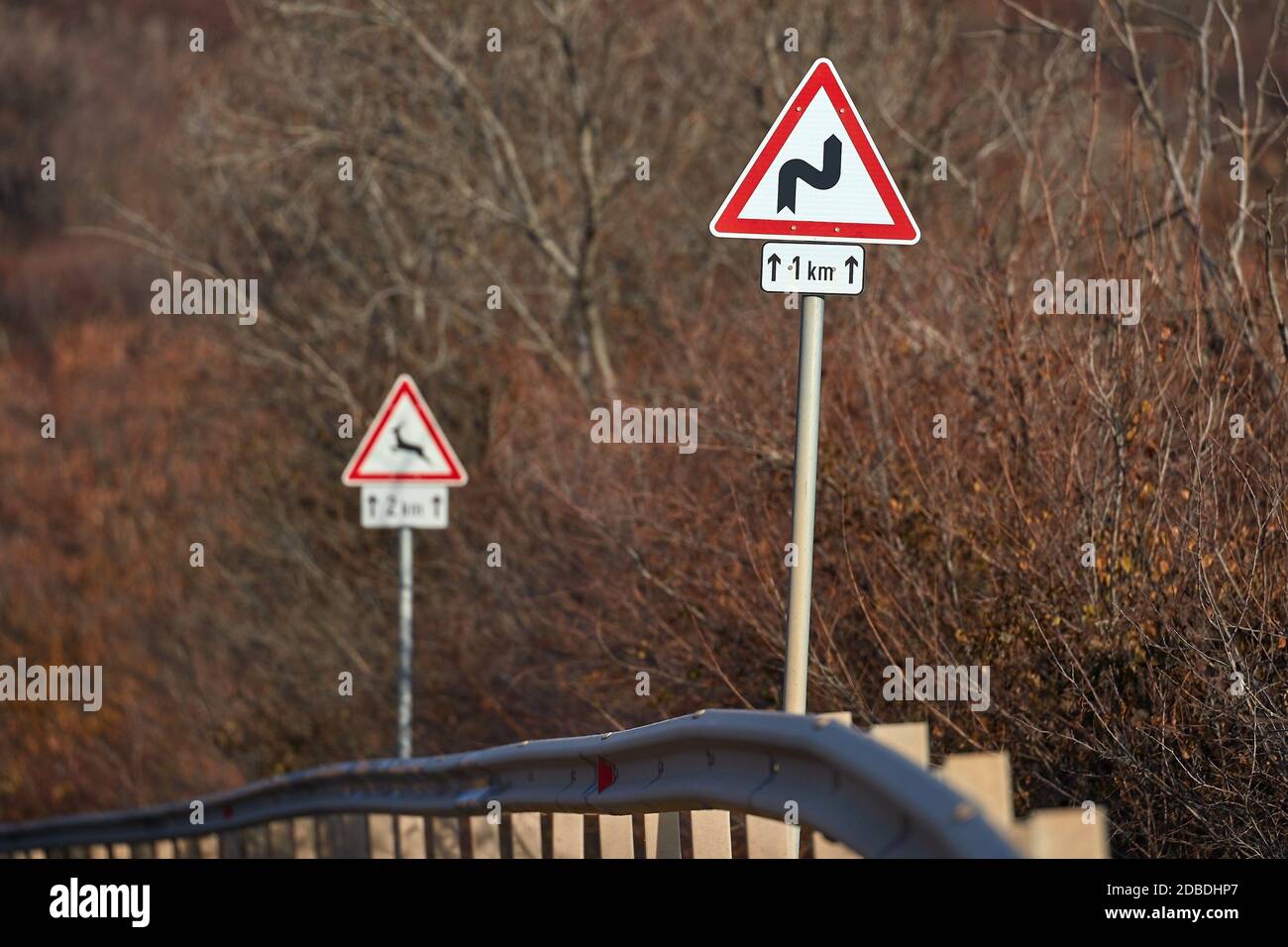 Curves coming traffic sign of a country road Stock Photo - Alamy