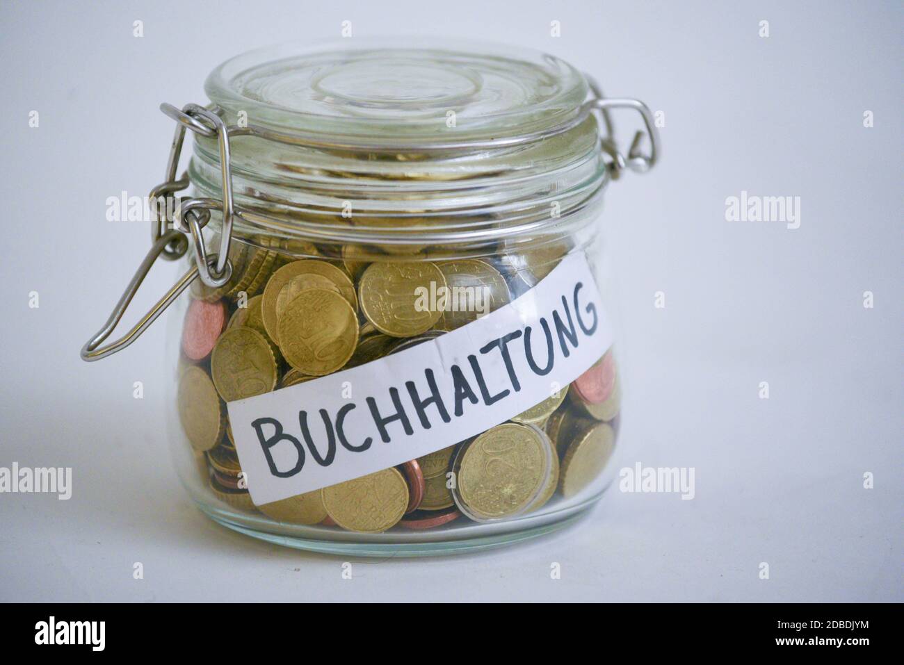 Jar with coins saying 'Buchhaltung' (accounting Stock Photo - Alamy
