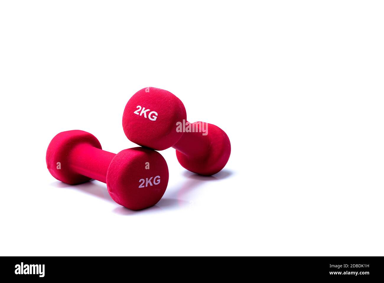 Set of red dumbbells isolated on white background. A pair of red neoprene dumbbells. Home gym ...